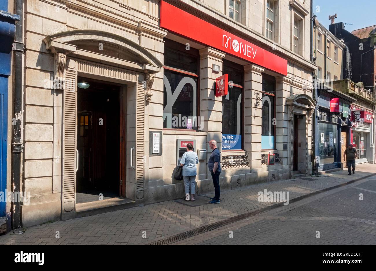 Virgin Money Bank branch and person using ATM cash machine on the high ...
