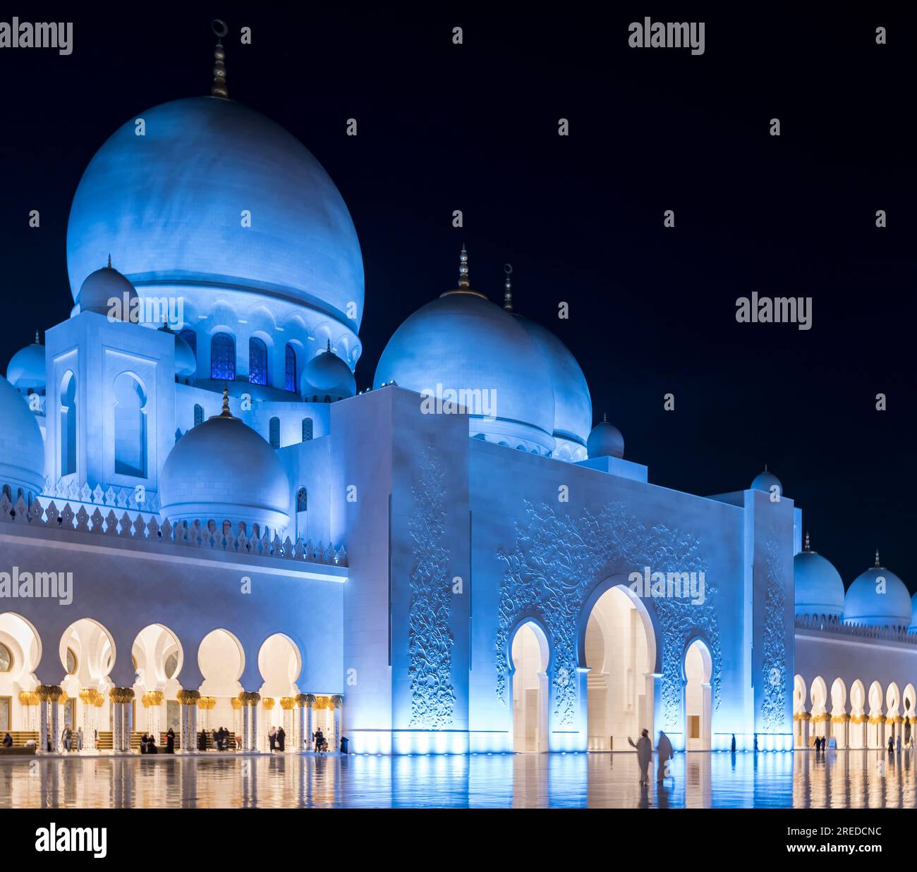 the entrance of Sheikh Zayed Grand Mosque in Abu Dhabi glows with a ...