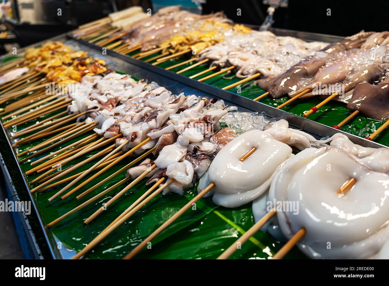 raw squid satay and given pile of ice cubes to keep it fresh and ready ...