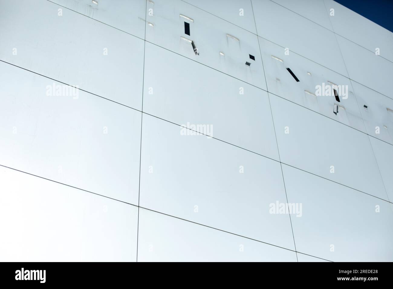Grey building on sunny day. Wall without windows. Modern architecture ...