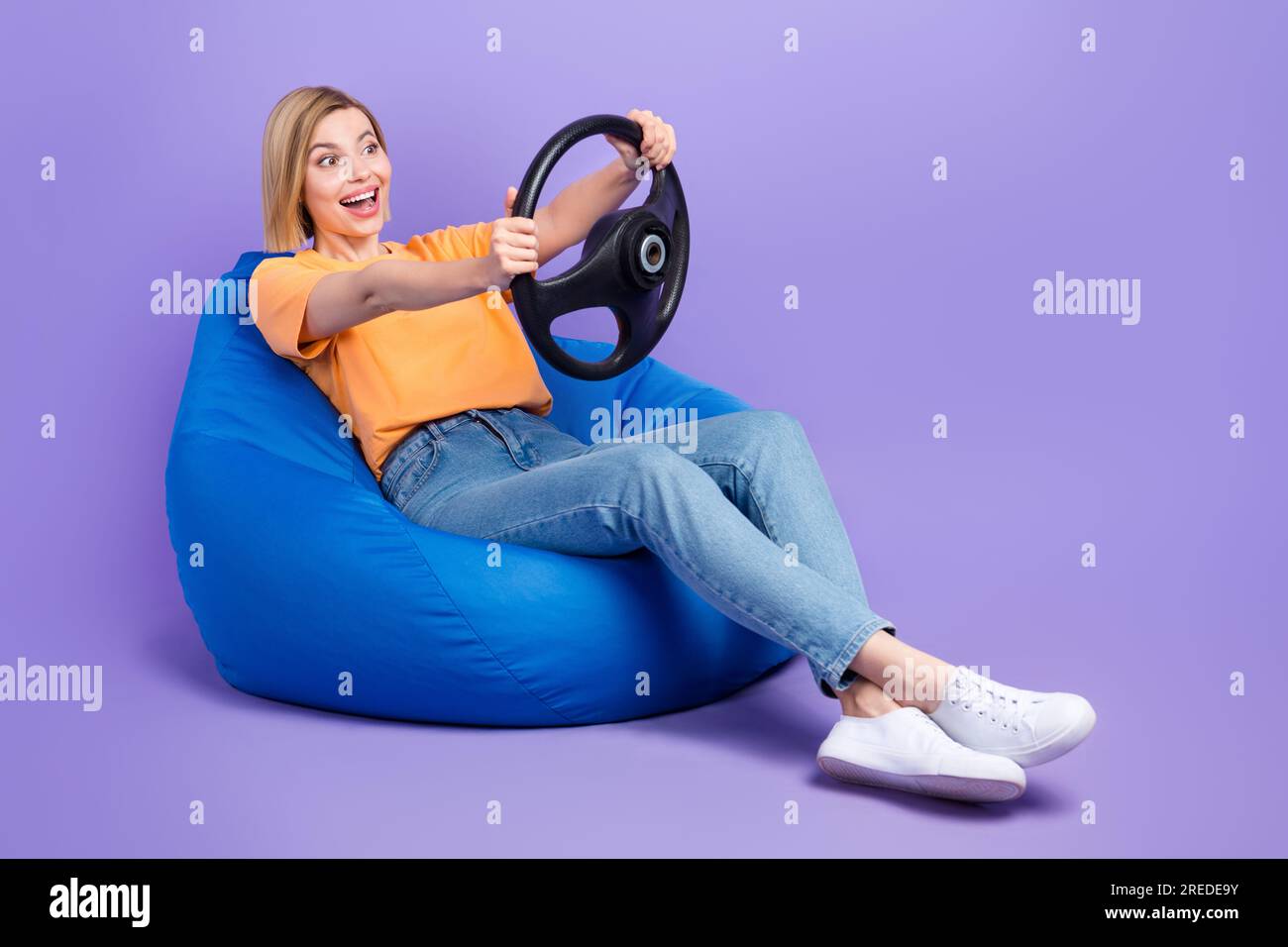 Full body cadre of driving simulation steering wheel traffic road woman ...