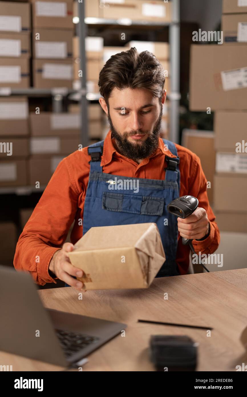 Logistics and transport worker in a warehouse full of goods for storage ...