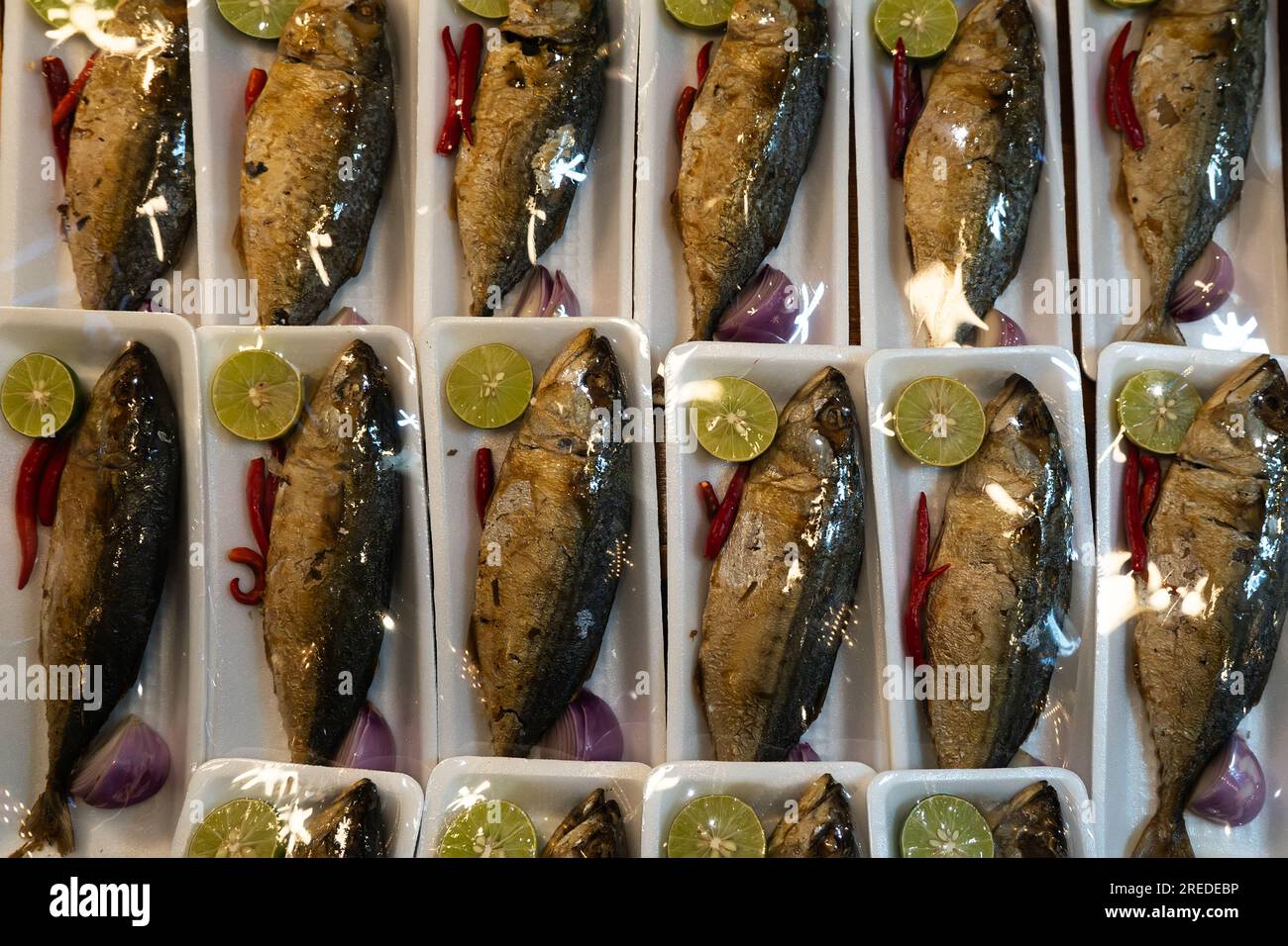 fried fish on a container. top view of fried fish in a package with ...