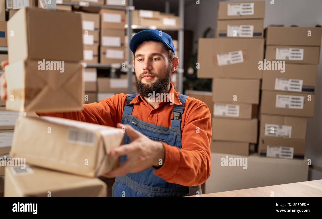 Warehouse worker take boxes in big warehouse factory, logistic service ...