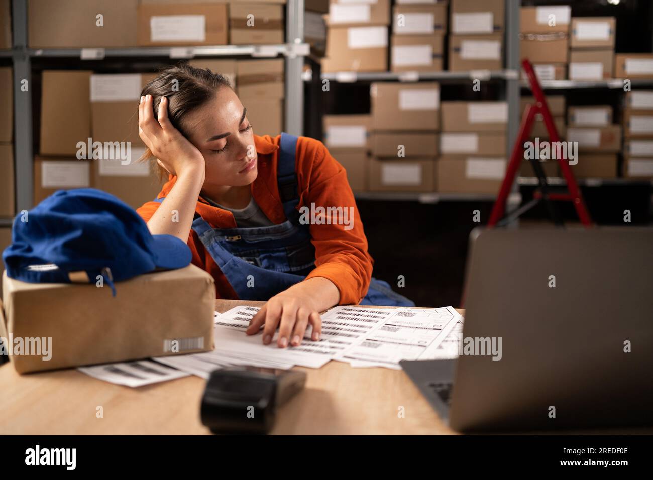 Tired stress woman worker labor working in warehouse cargo inventory ...