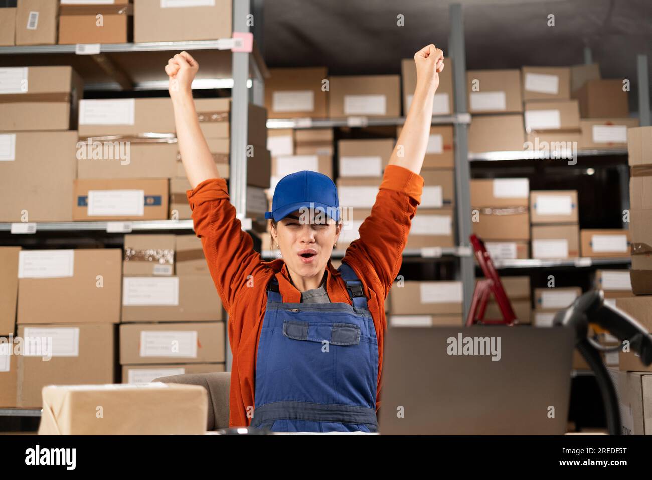 Happy warehouse worker celebrate win and success. Logistic business, success and people concept ...