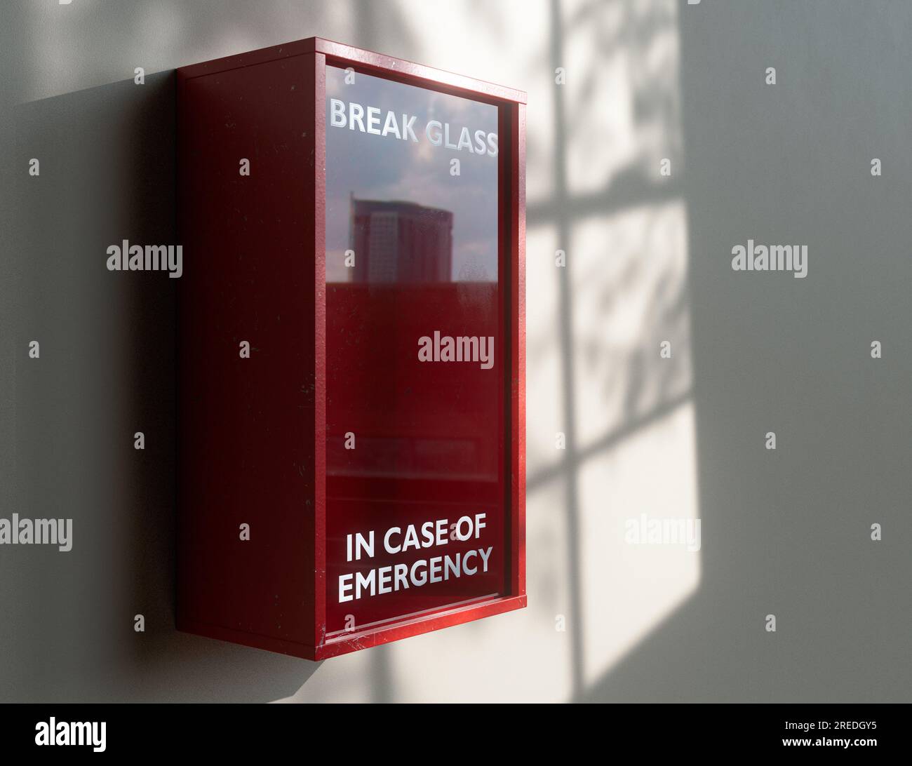 An empty red emergency box with an in case of emergency breakable glass ...