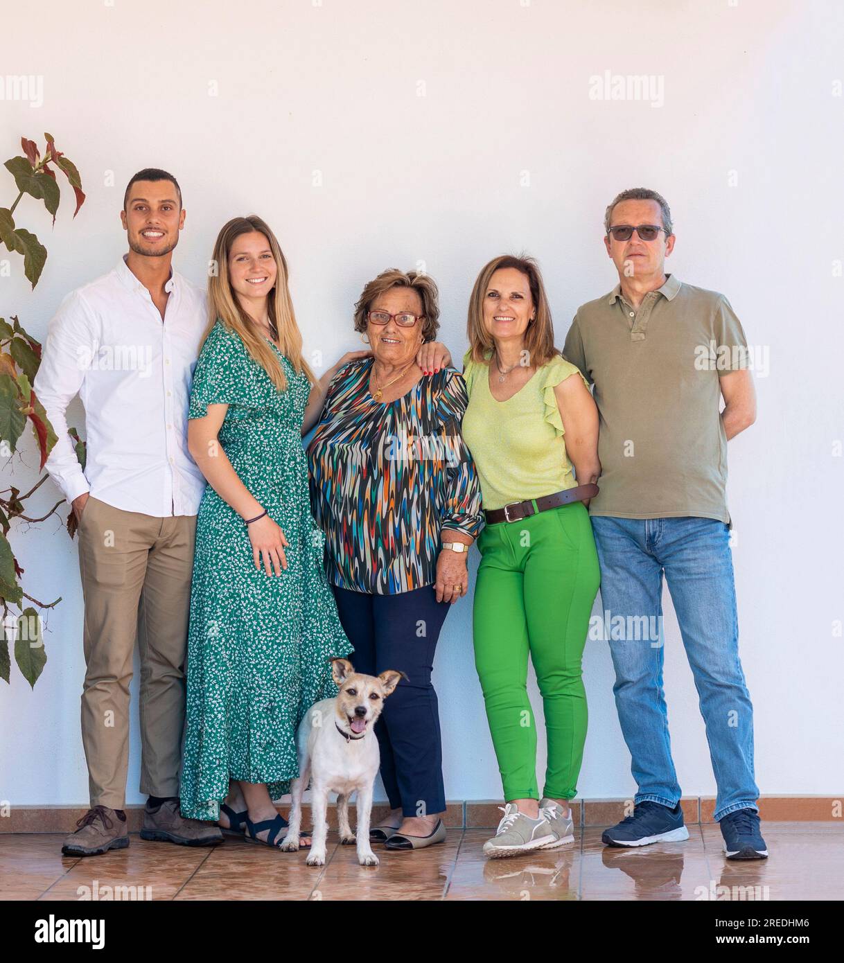 Happy smiling European family with puppy dog over white background ...