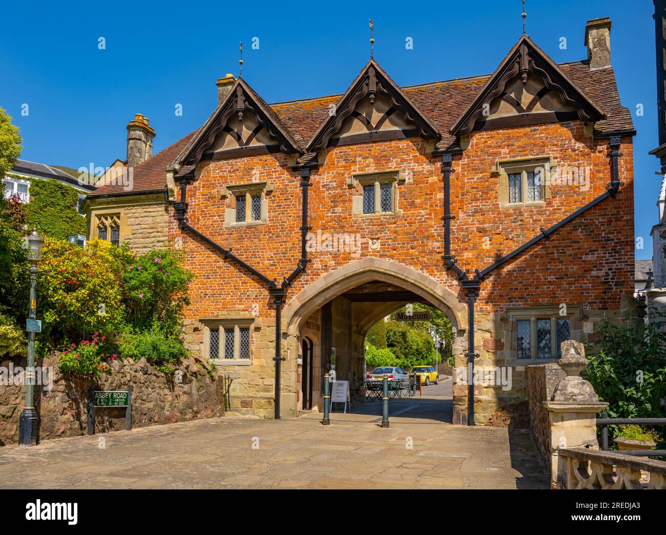The Malvern Museum in a 15th-century brick gatehouse. Next to The Abbey ...
