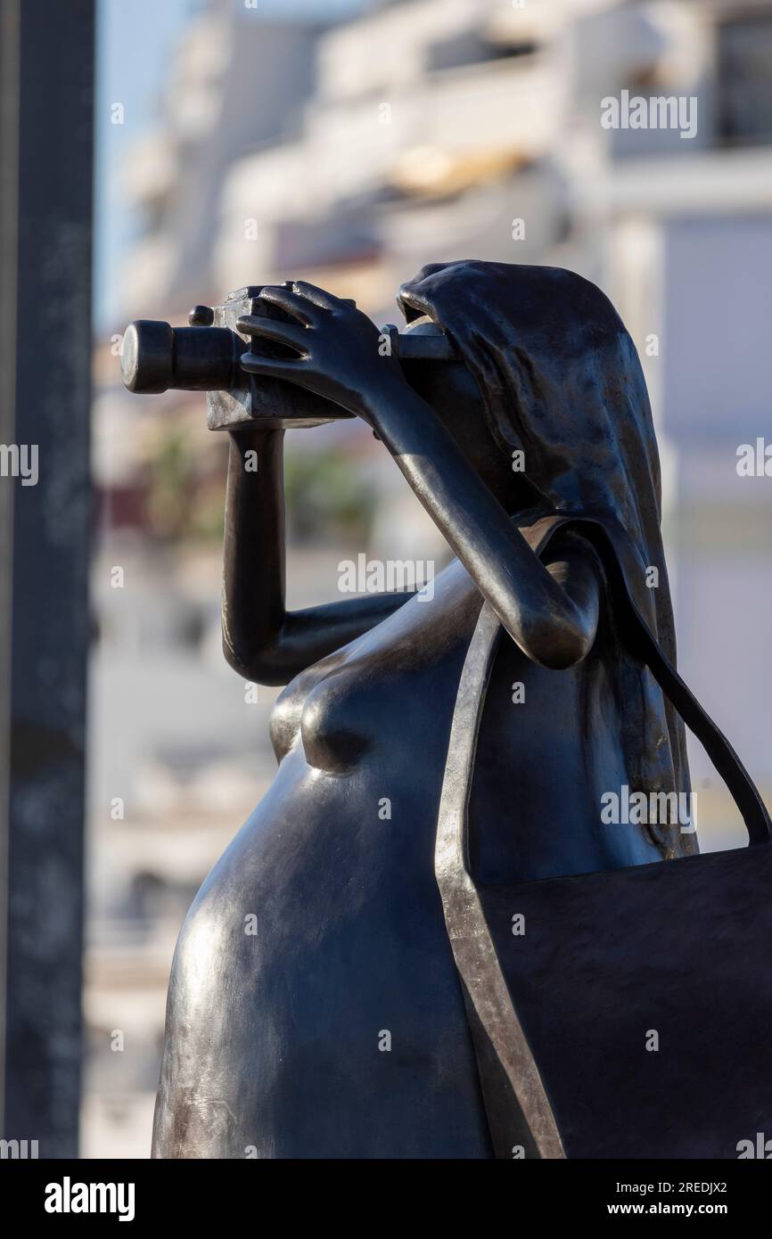 Close up view of a Female tourist bronze statue using binoculars Stock ...