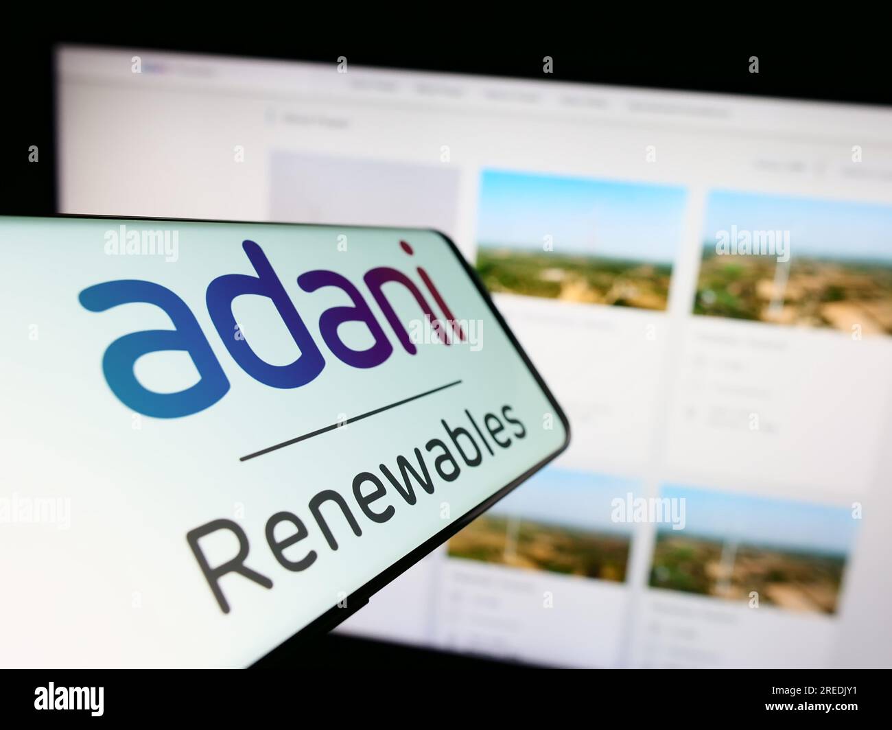 Cellphone with logo of Indian company Adani Green Energy Limited on ...