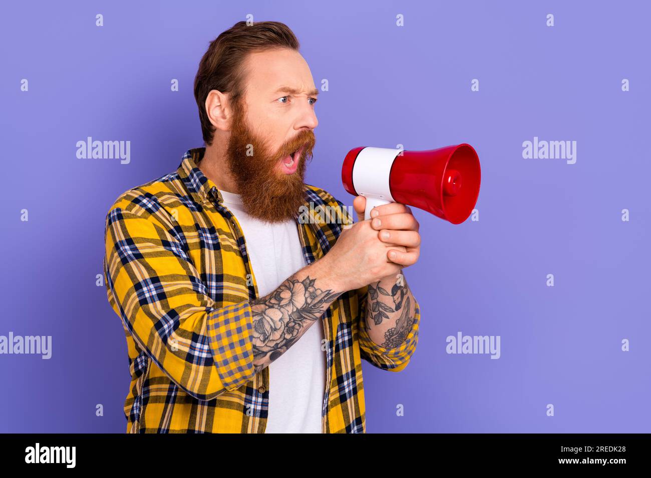 Profile photo of unsatisfied furious impressed man hold loudspeaker toa ...