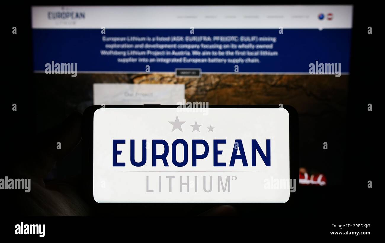 Person holding smartphone with logo of mining company European Lithium ...