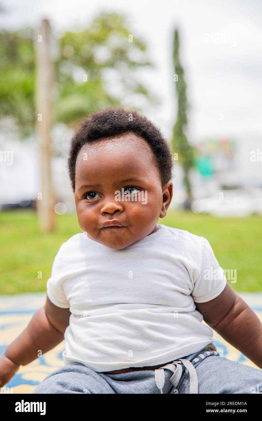 Portrait of an African baby outdoors in a park, vertical photo Stock ...
