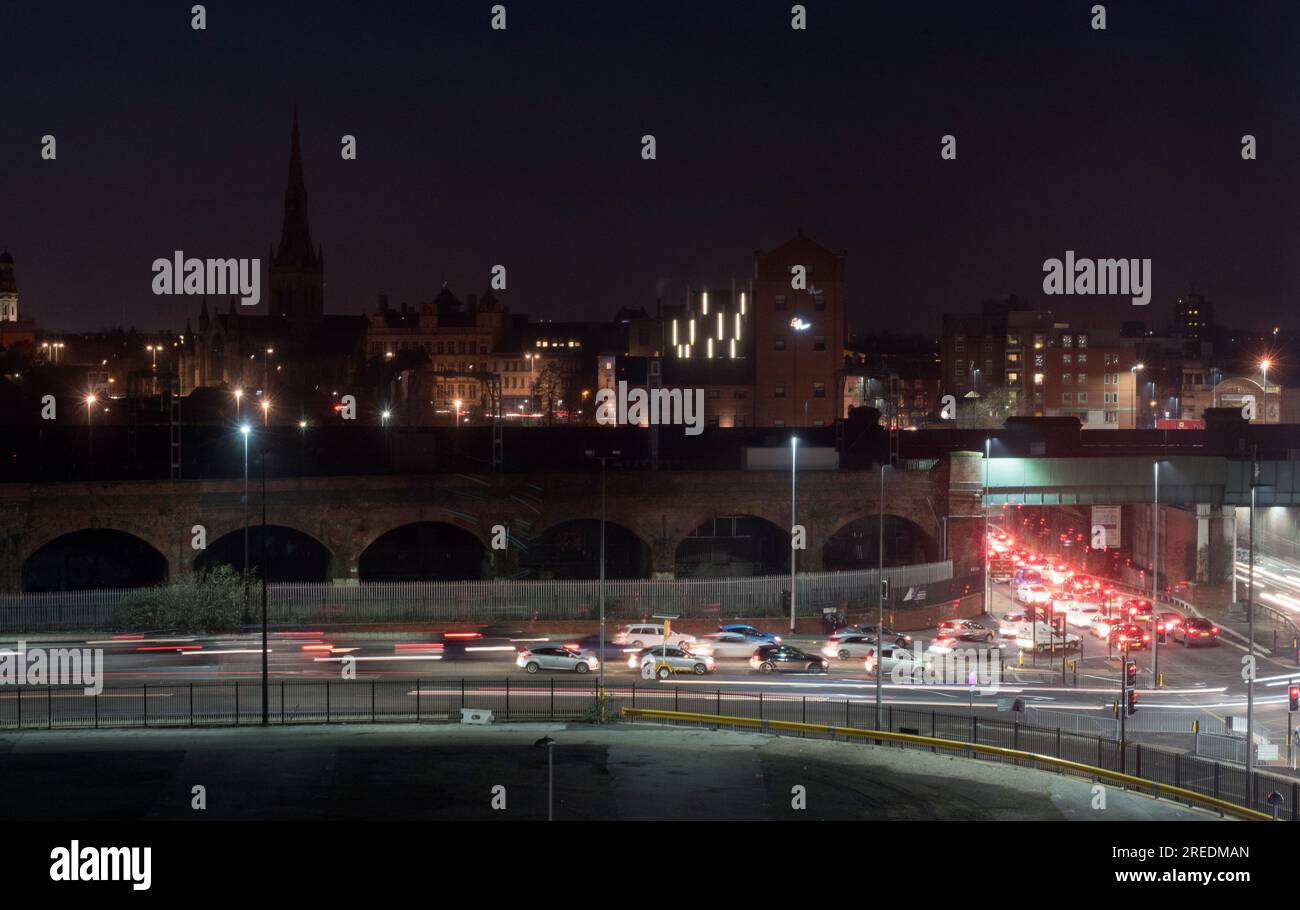 Traffic at night with car light trails on a city centre street in ...