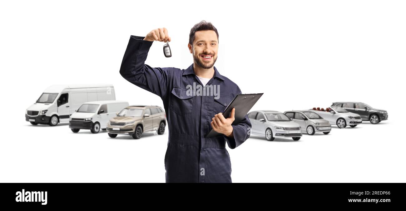 Auto mechanic holding keys at a car park isolated on white background ...