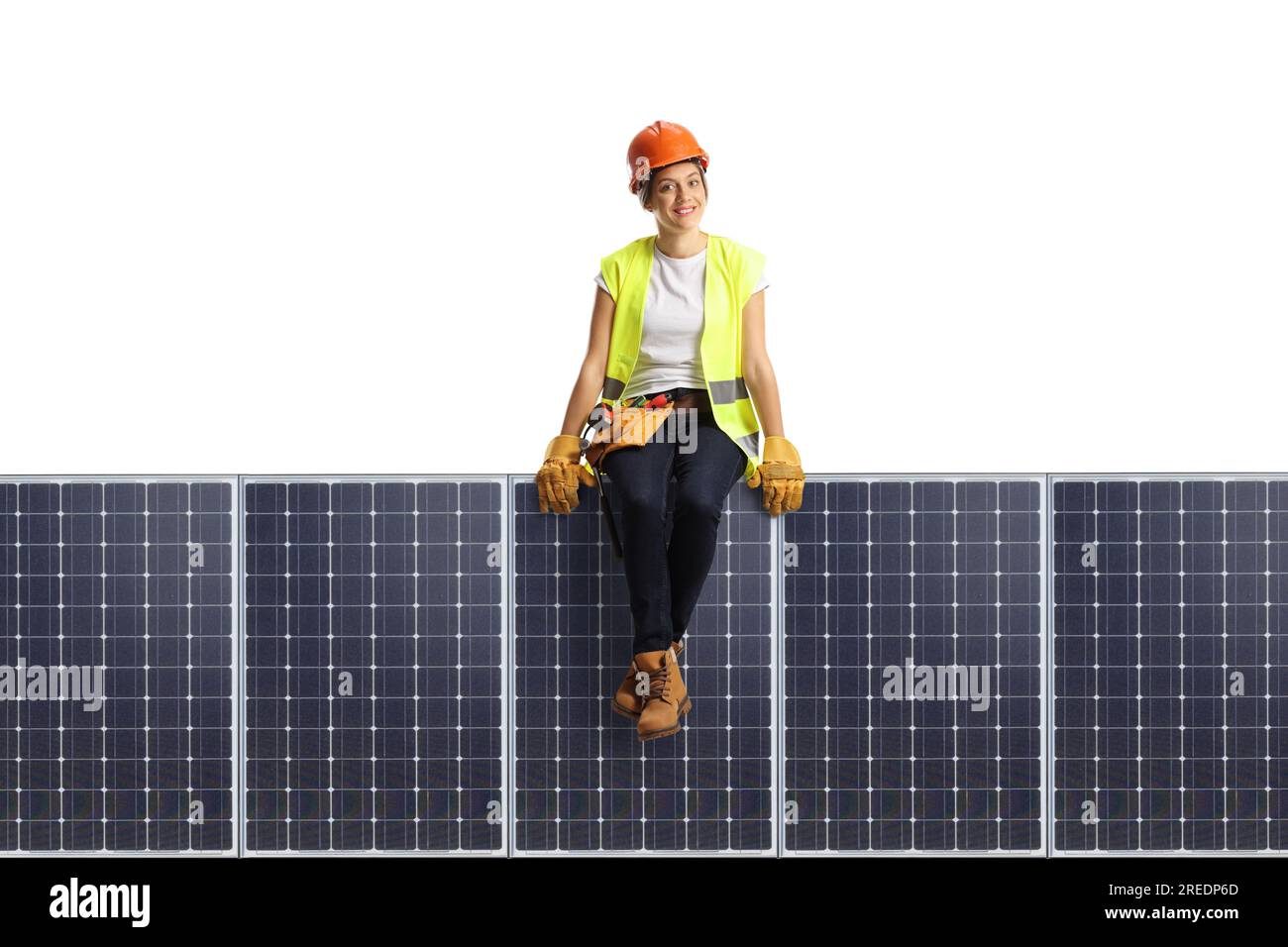 Full length portrait of a female construction worker sitting on a solar ...