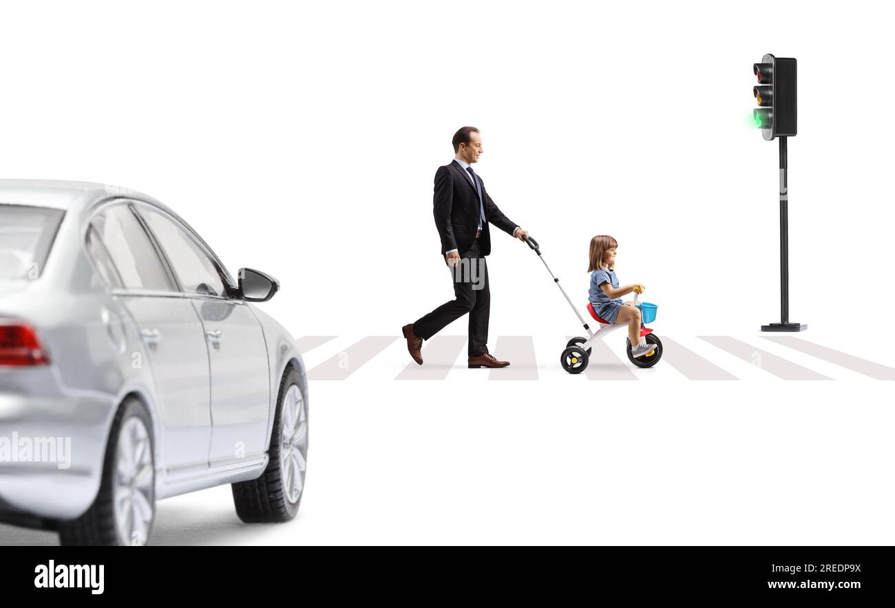 Father pushing a child on a tricycle at a pedestrian crossing isolated ...