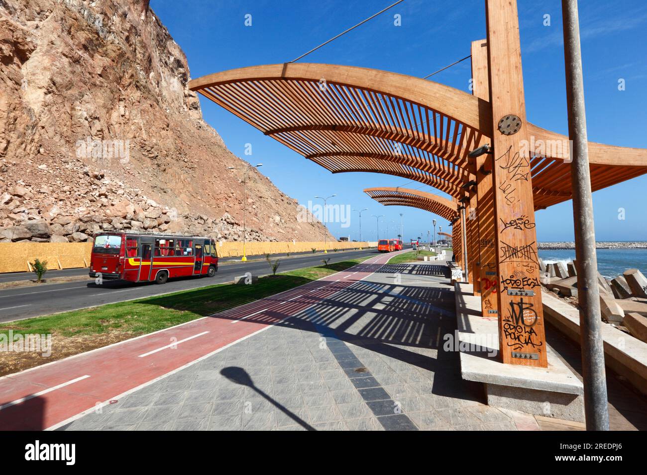 Wooden bus shelter and public transport buses on Av Costanera / Av ...