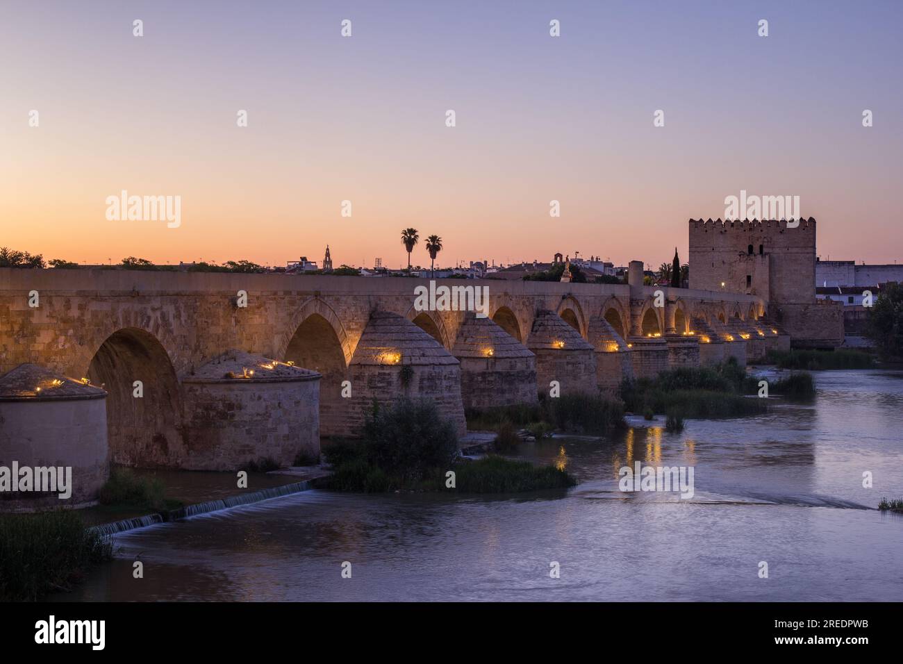 Ancient roman bridge across the Guadalquivir river in the morning ...