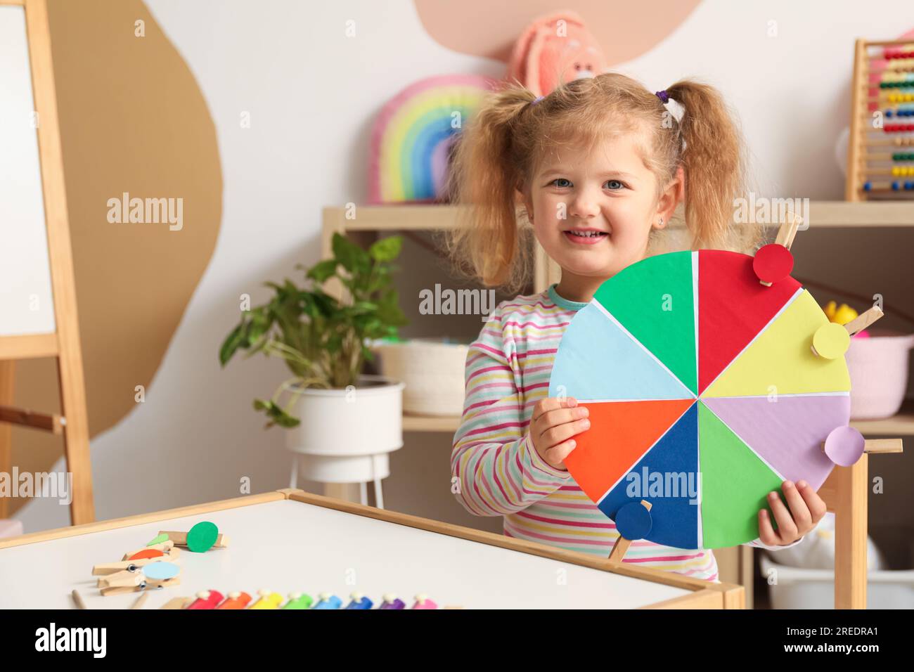 Cute little girl with matching game at home Stock Photo - Alamy