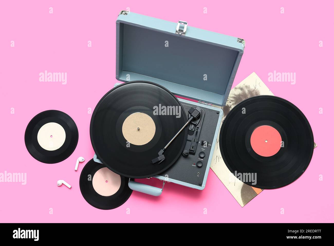Record player with vinyl disks on pink background Stock Photo - Alamy