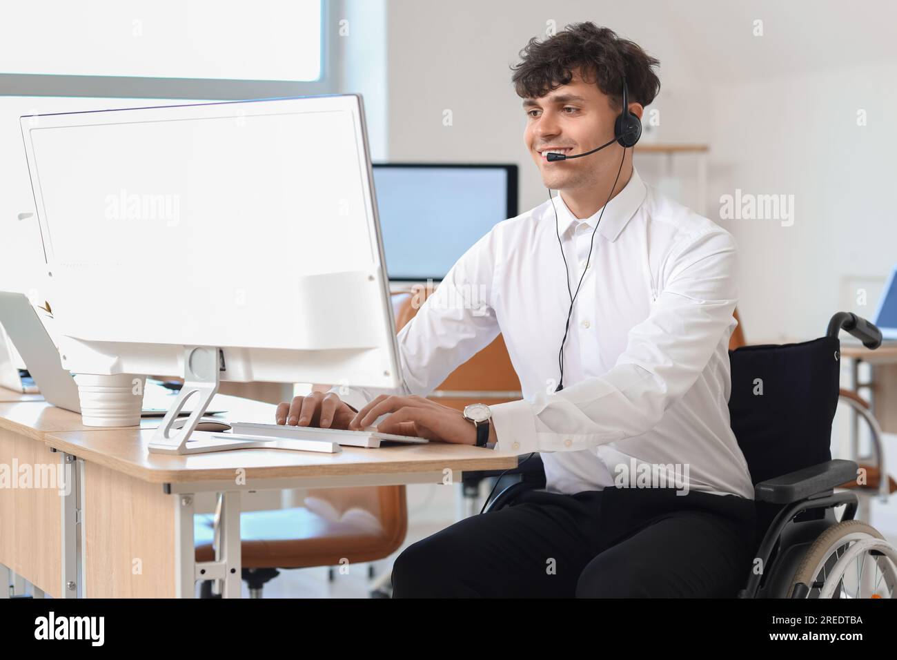Male technical support agent working in office Stock Photo - Alamy