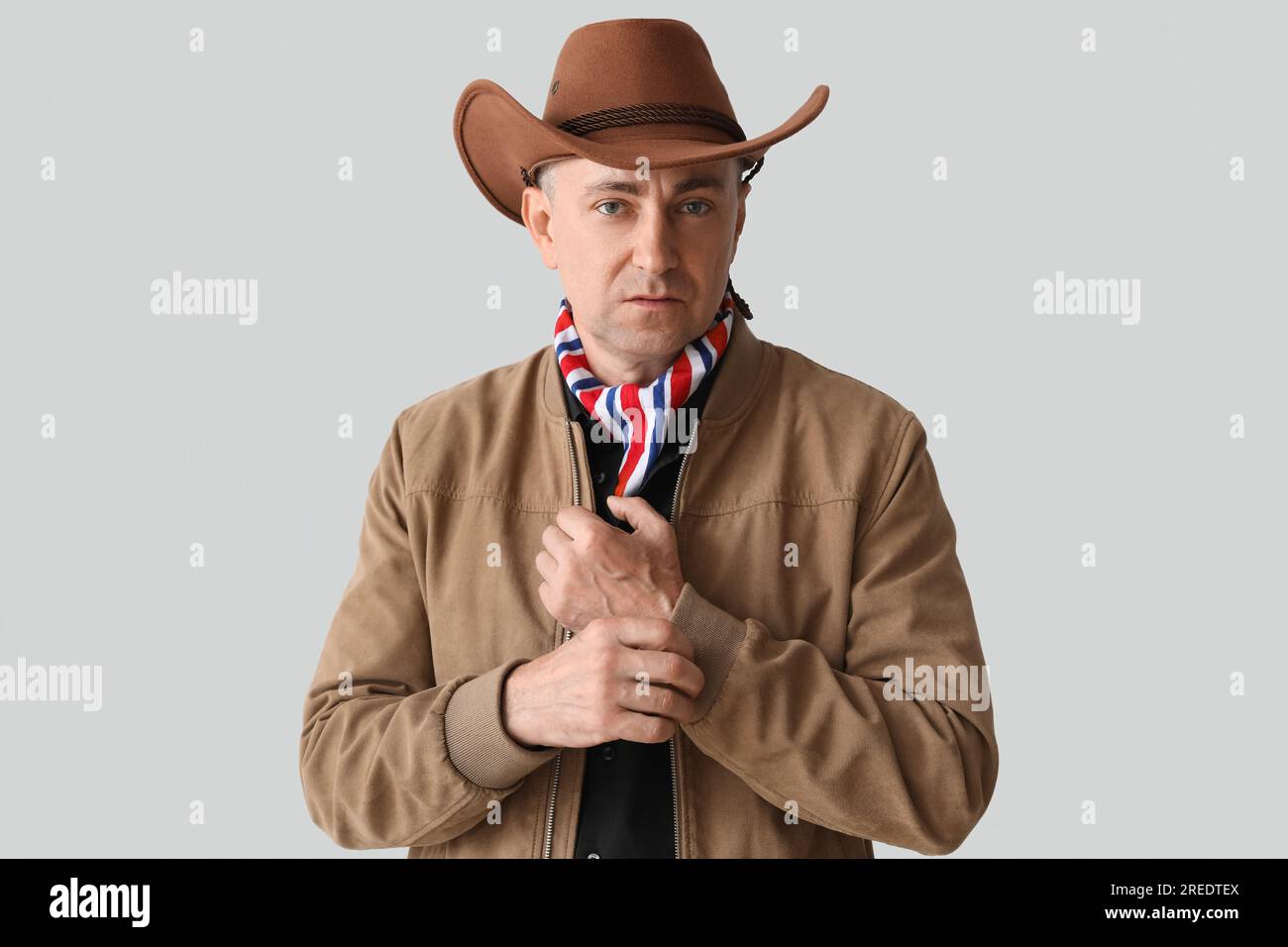 Mature cowboy on light background Stock Photo - Alamy