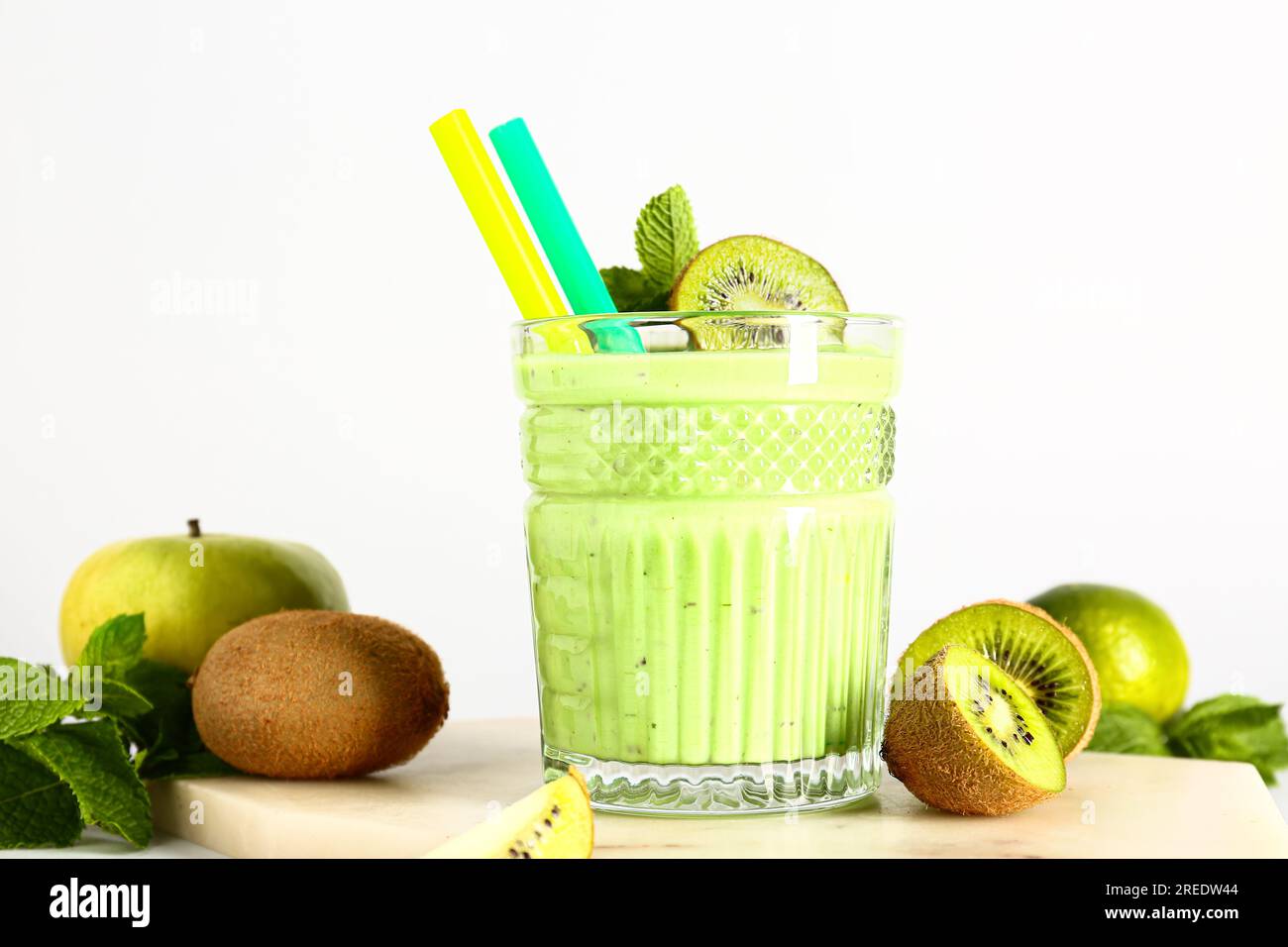 Board With Glass Of Fresh Kiwi Smoothie And Mint On White Background