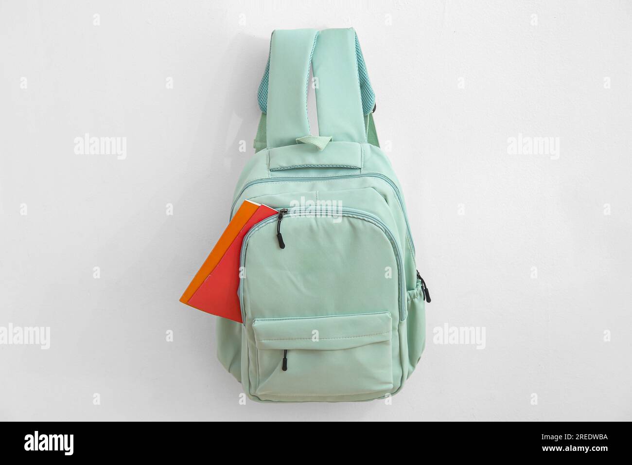 Green school backpack with stationery on white background Stock Photo ...