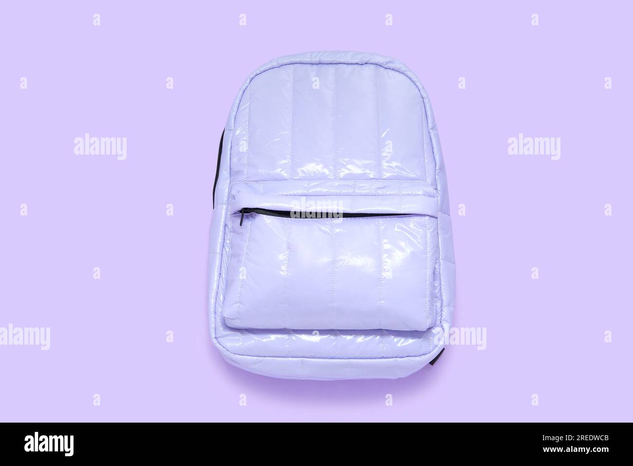 Lilac school backpack on purple background Stock Photo - Alamy
