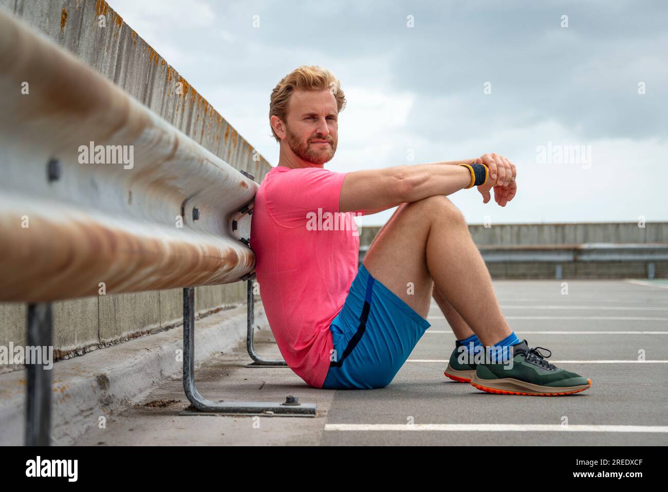 Fit sporty man resting after exercise running, urban backdrop Stock ...