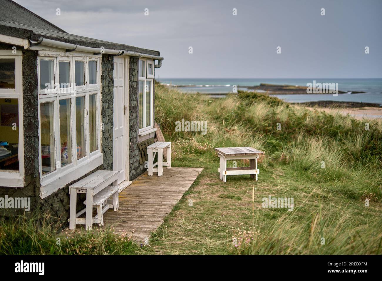 Wooden beach house in the sand dunes overlooking Embleton Bay in ...