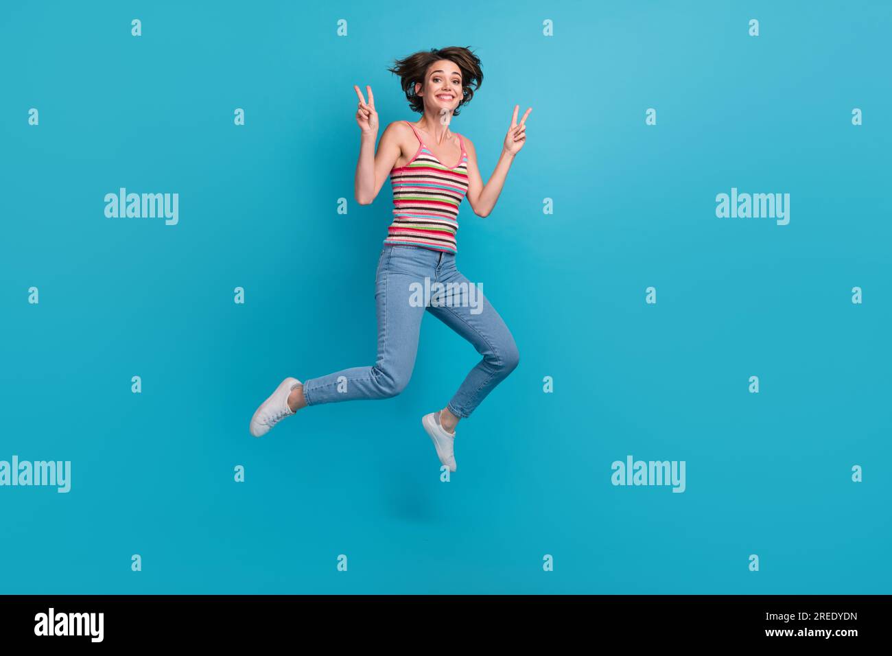 Full size photo of energetic cheerful girl jumping hands fingers ...