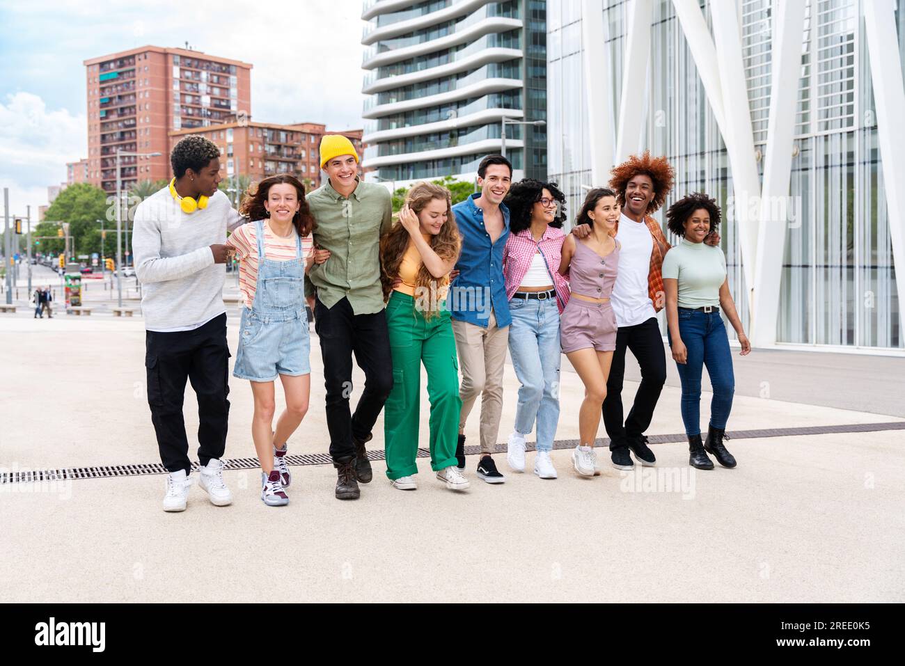 Happy playful multiethnic group of young friends bonding outdoors ...