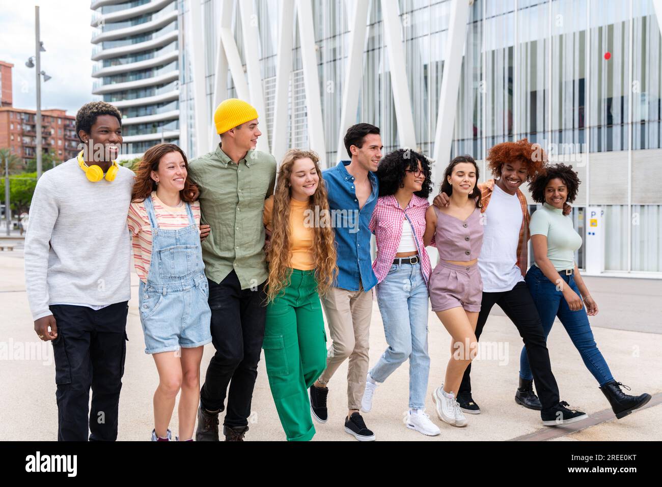 Happy playful multiethnic group of young friends bonding outdoors ...
