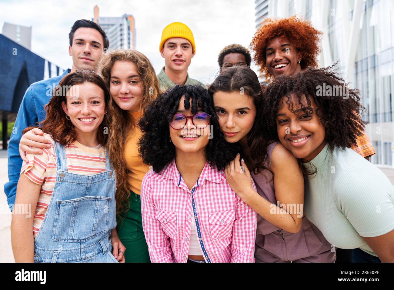 Happy playful multiethnic group of young friends bonding outdoors ...