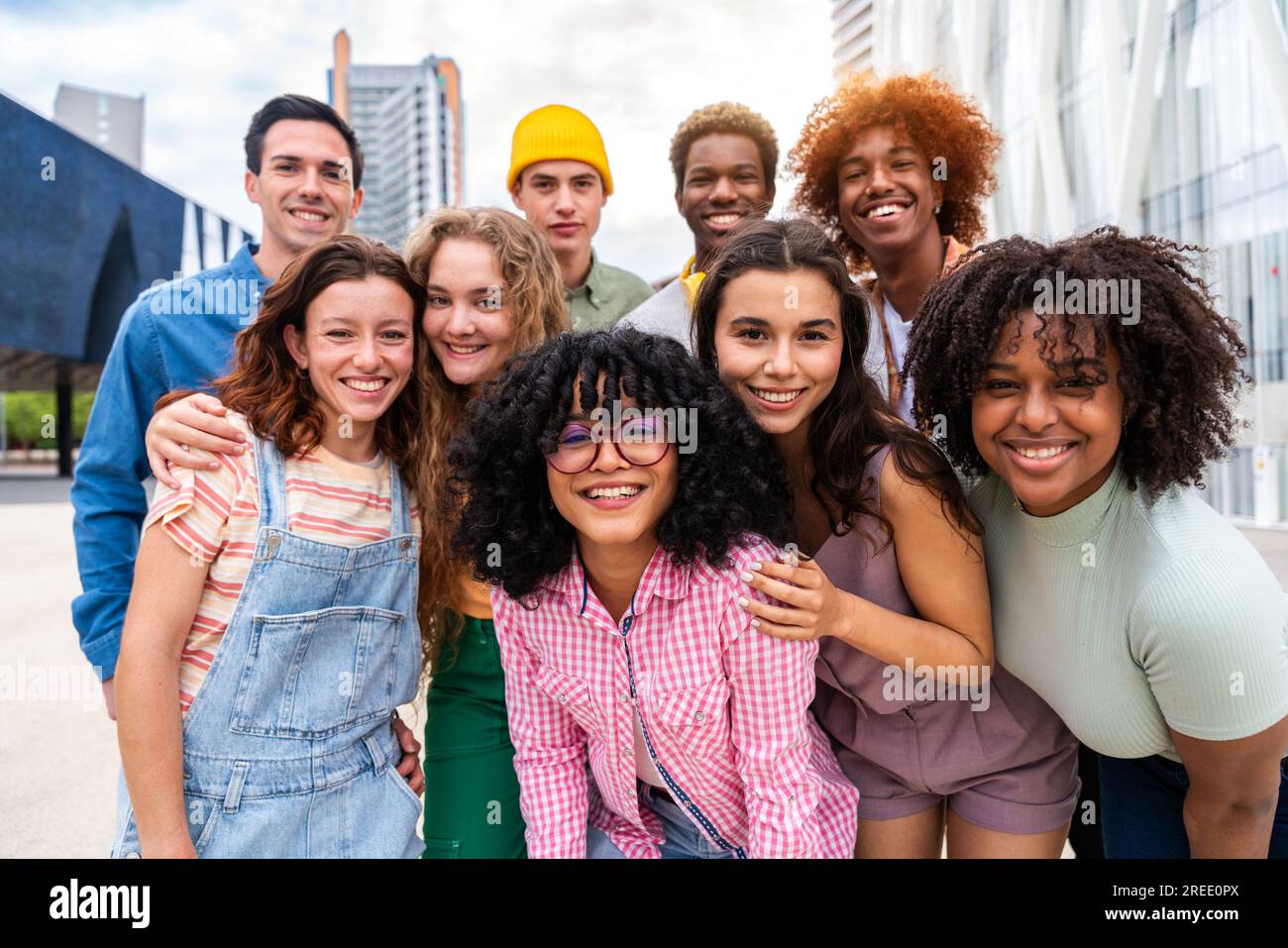 Happy playful multiethnic group of young friends bonding outdoors ...