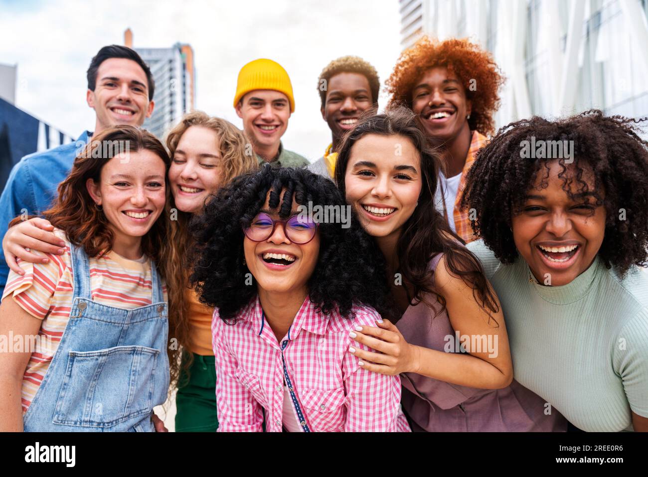 Happy playful multiethnic group of young friends bonding outdoors ...