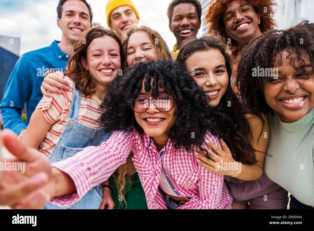 Happy playful multiethnic group of young friends bonding outdoors - Multiracial millennials ...
