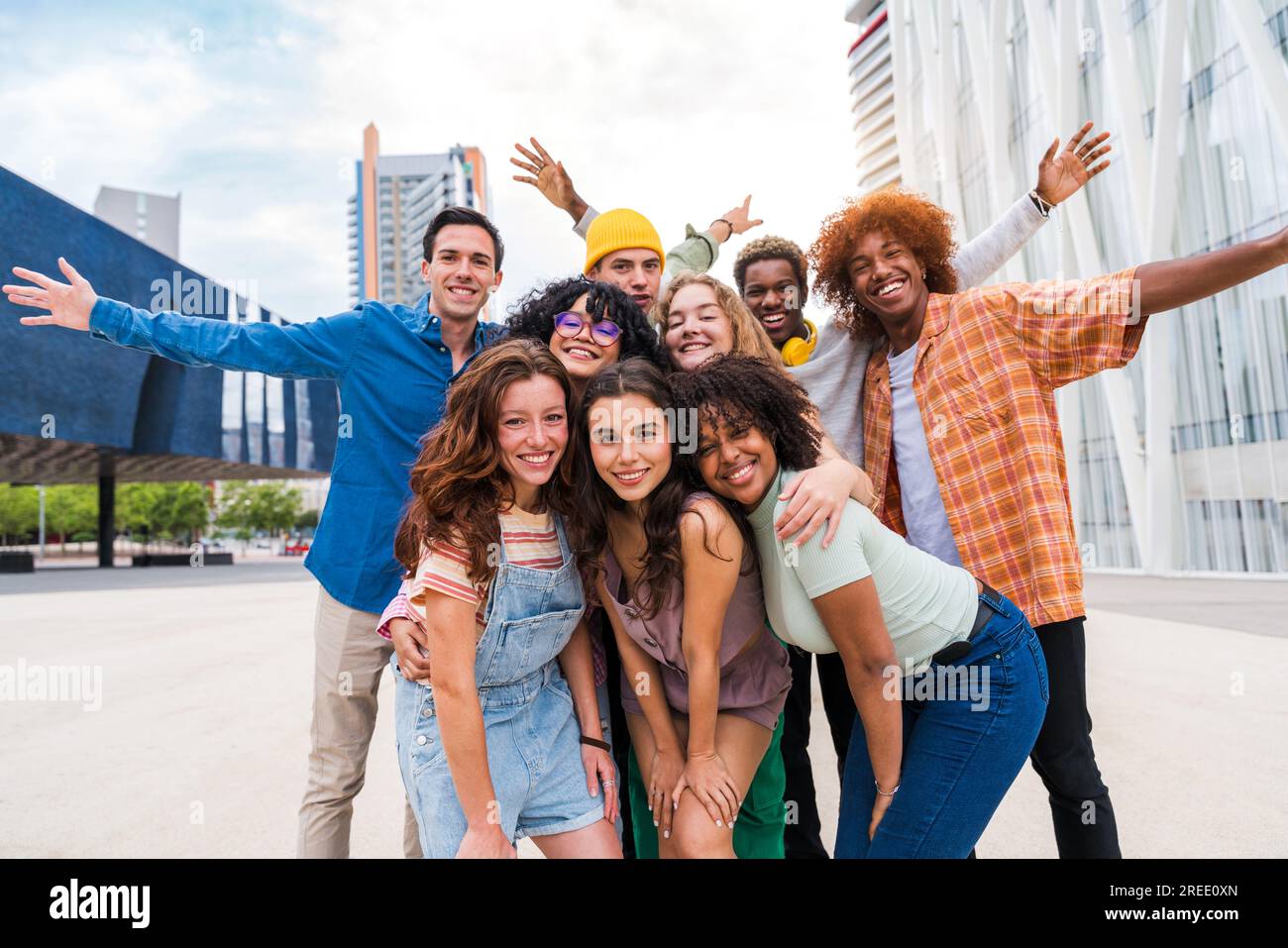 Happy playful multiethnic group of young friends bonding outdoors ...