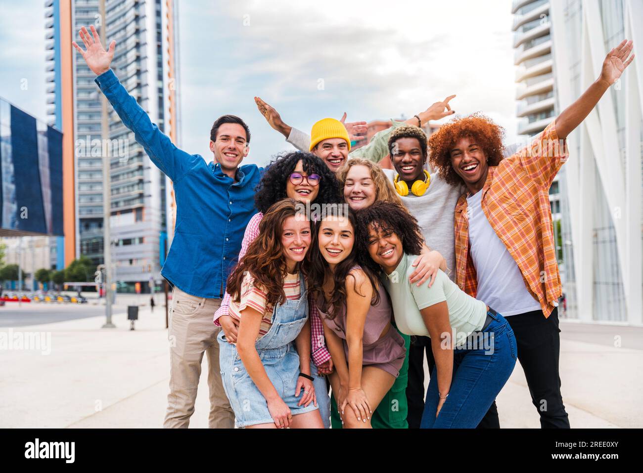 Happy playful multiethnic group of young friends bonding outdoors ...