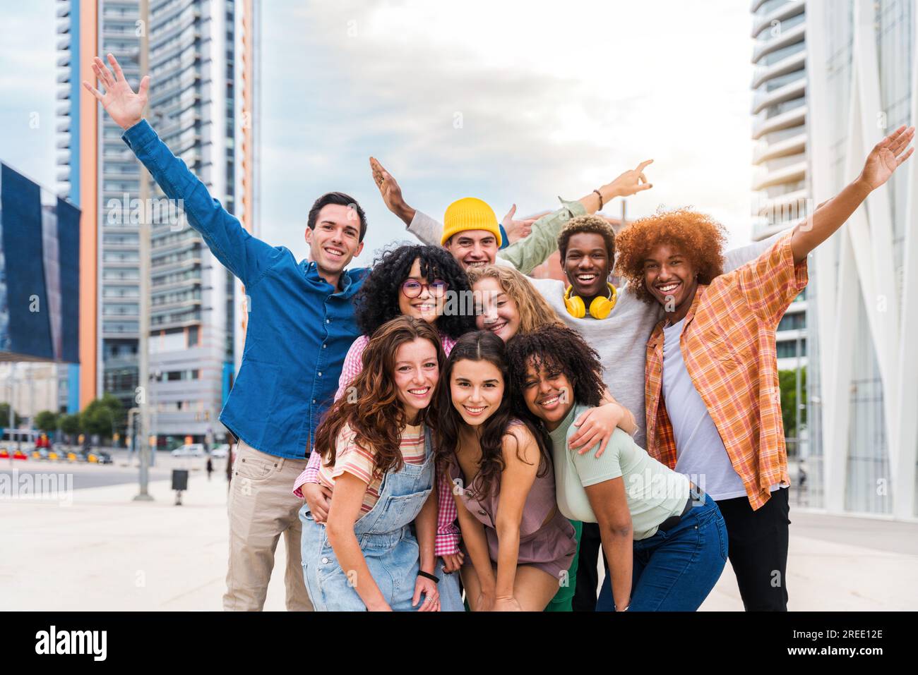 Happy playful multiethnic group of young friends bonding outdoors ...