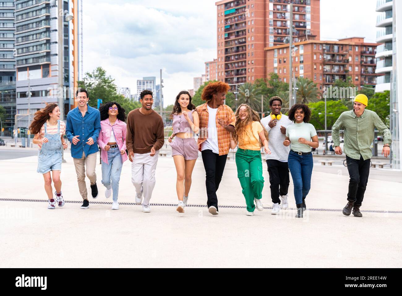 Happy playful multiethnic group of young friends bonding outdoors ...