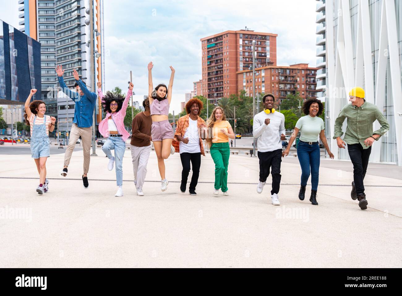 Happy playful multiethnic group of young friends bonding outdoors ...
