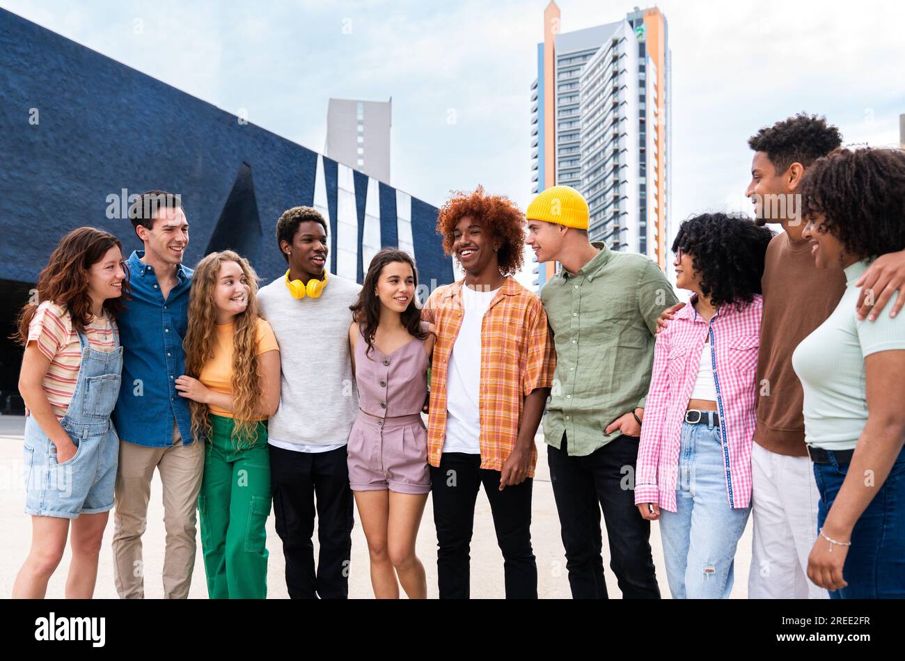 Happy playful multiethnic group of young friends bonding outdoors ...