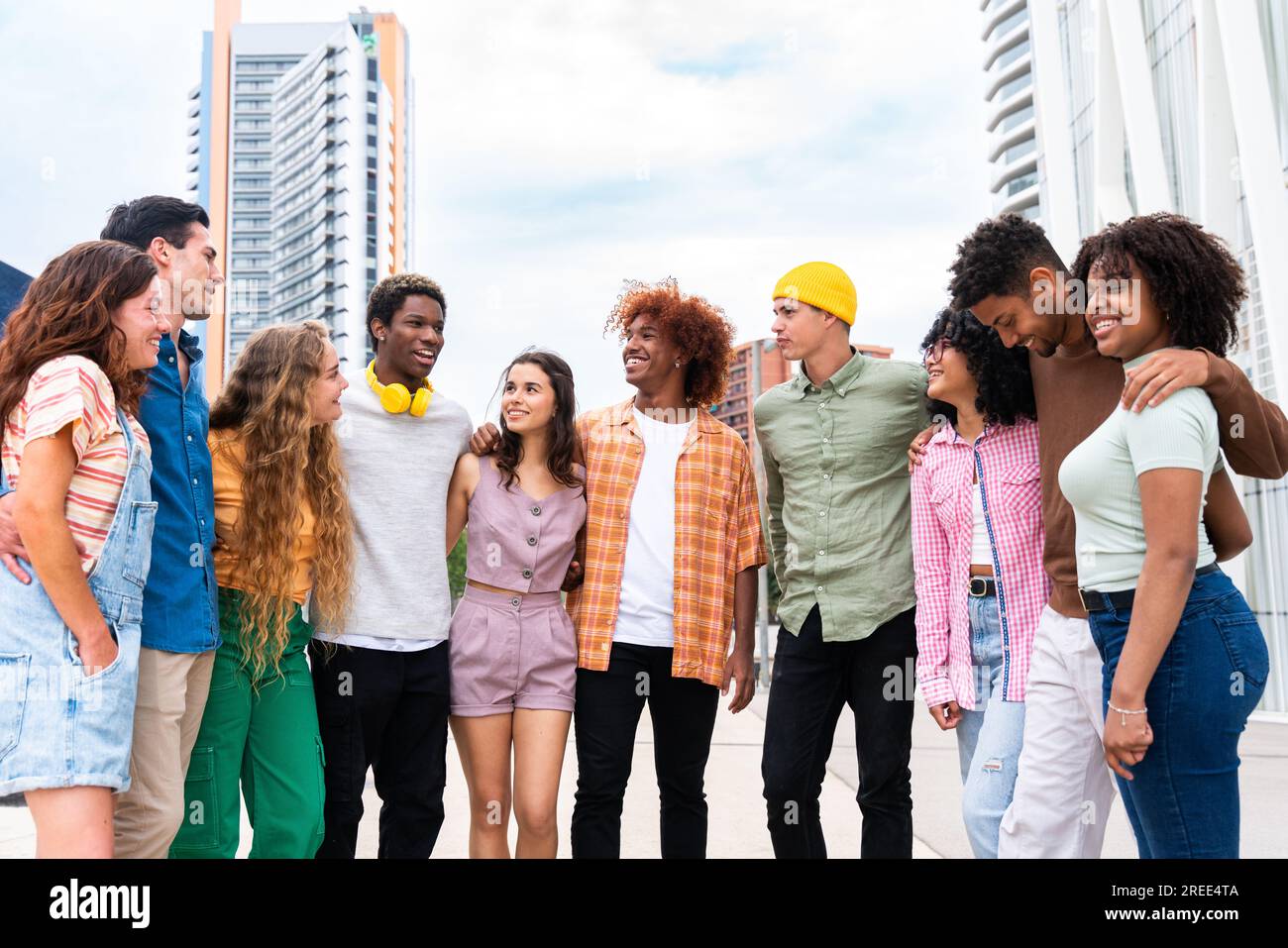 Happy playful multiethnic group of young friends bonding outdoors ...