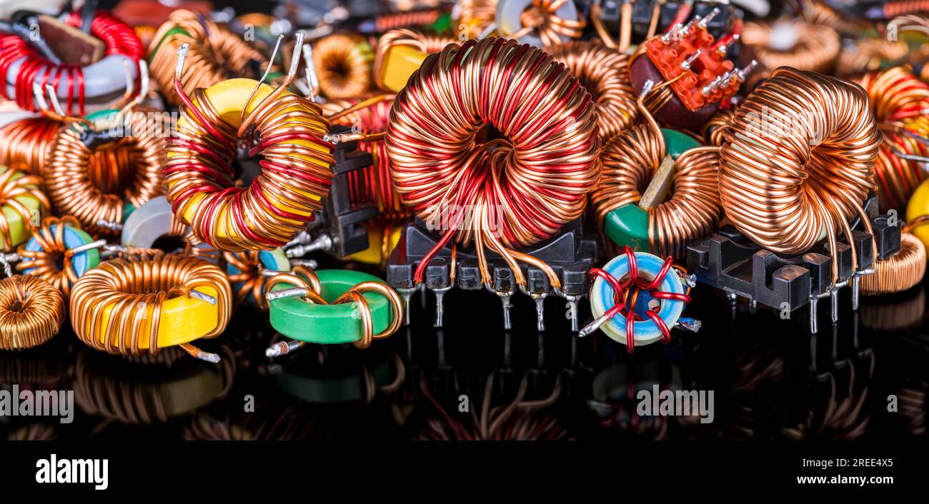 Closeup Of Colored Inductors Or Transformers And Reflection On Black
