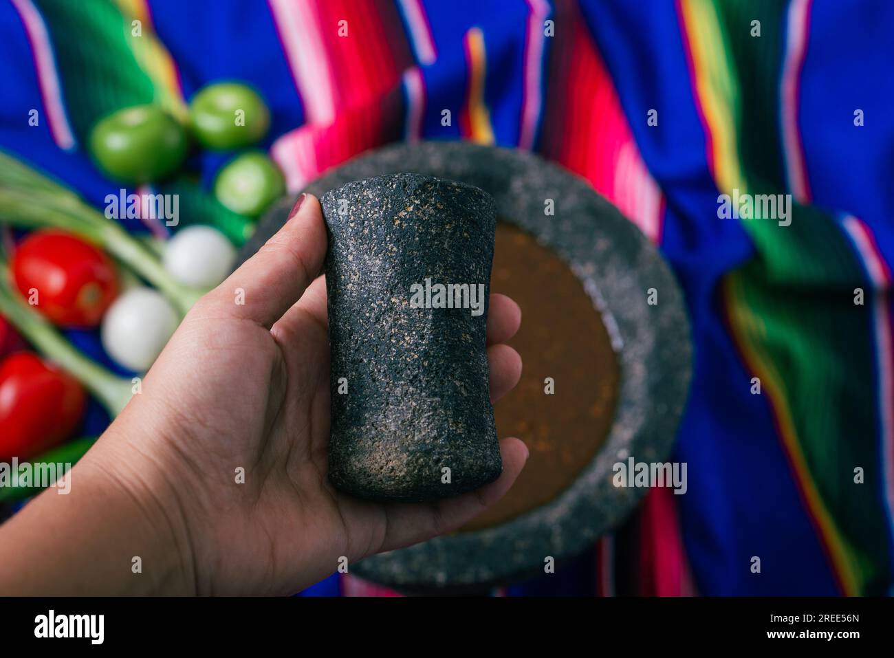 Hand of a person showing the molcajete temolote Stock Photo - Alamy