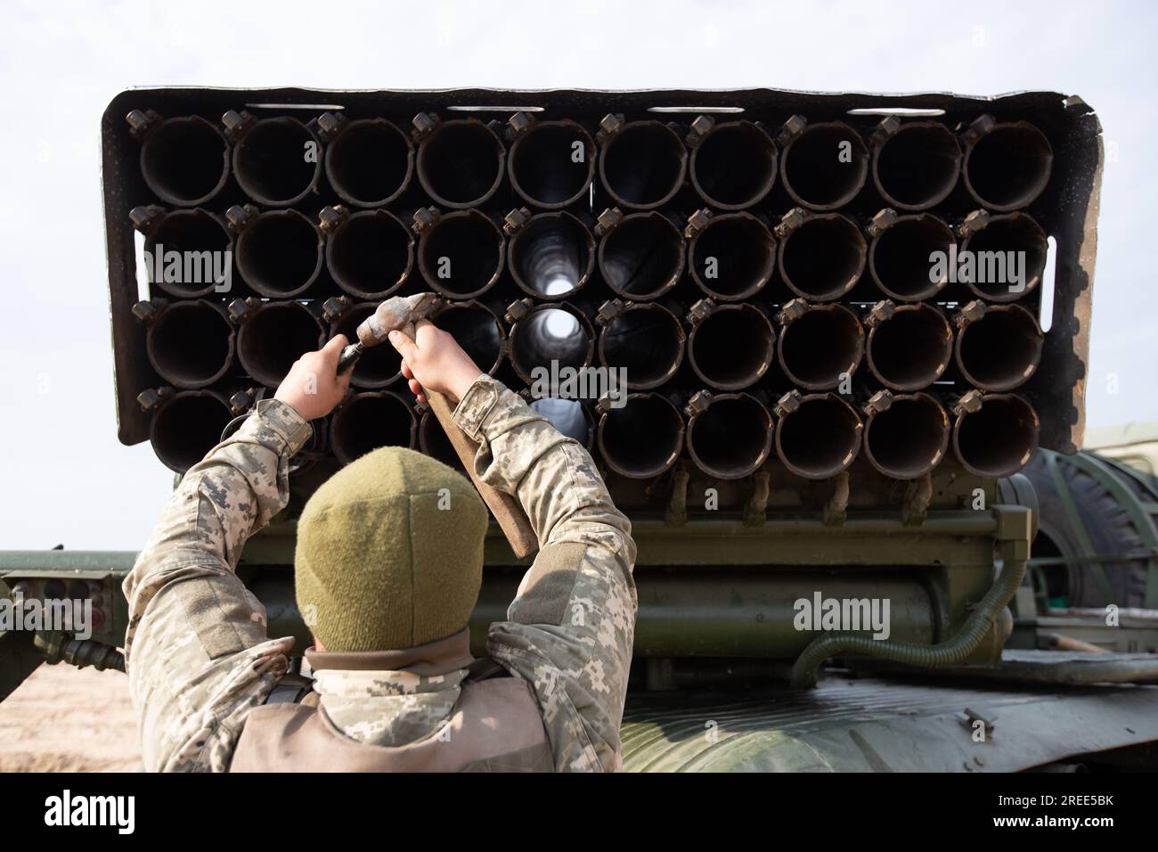 Soldier of Ukrainian army loads a multiple launch rocket system BM-21 ...